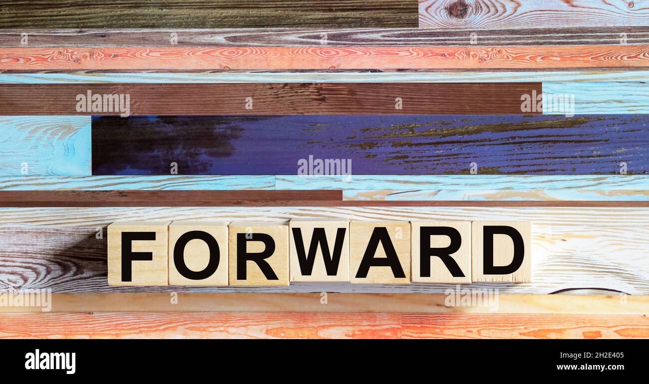 FORWARD - The word is written on wooden blocks that lie on a striped ...