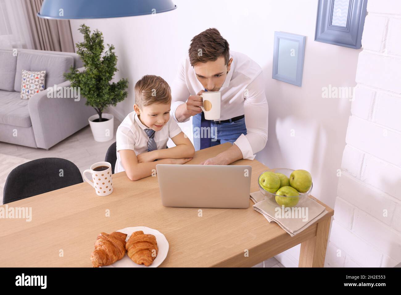 Dad and his son with laptop at home Stock Photo - Alamy