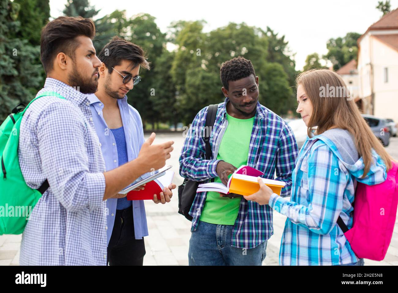 The multinational students talk to each other about books Stock Photo ...