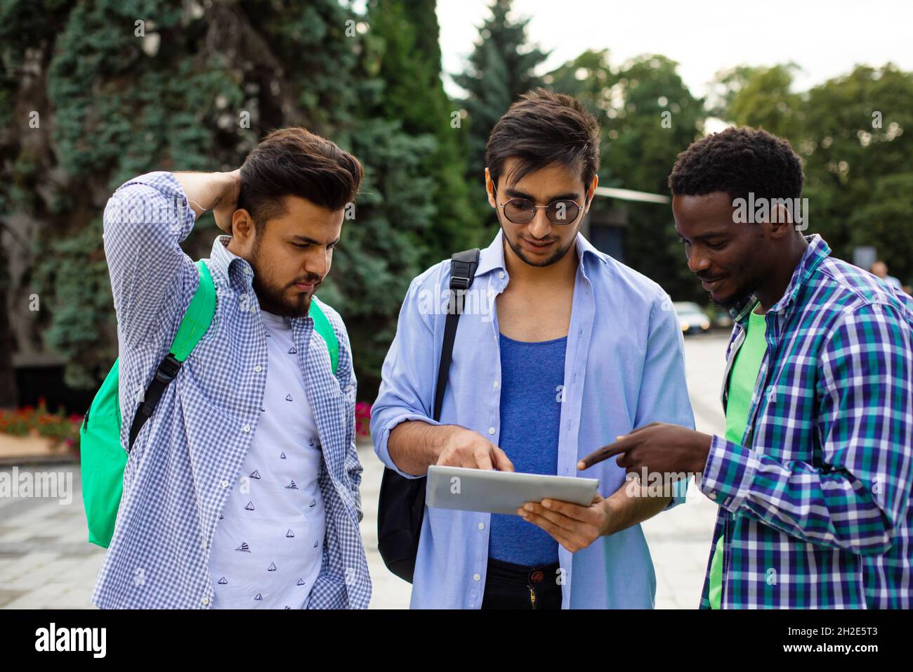The group of indian students help your classmate with navigation Stock ...