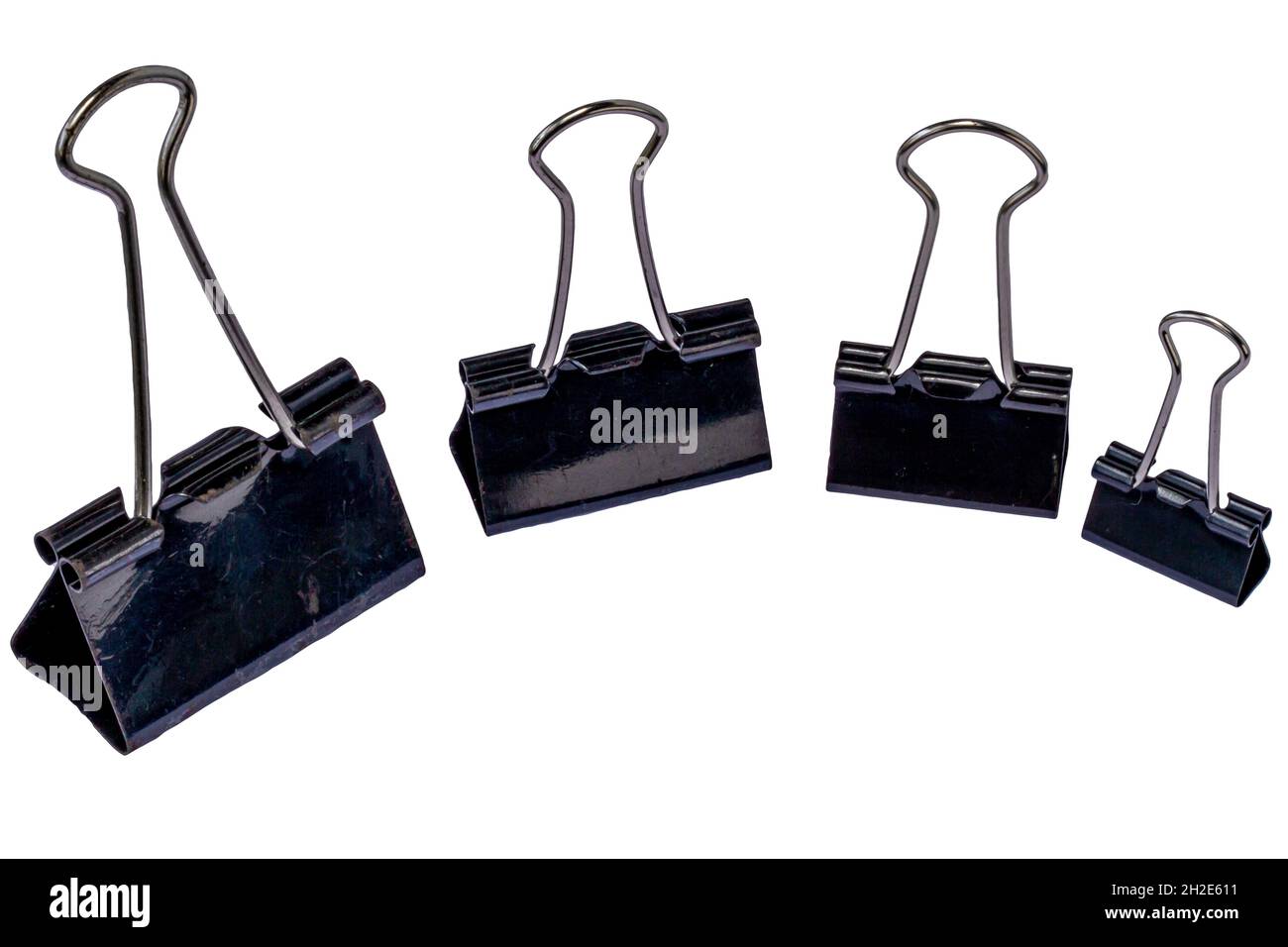 Four black metal paper clips, isolated with a white background, for ...