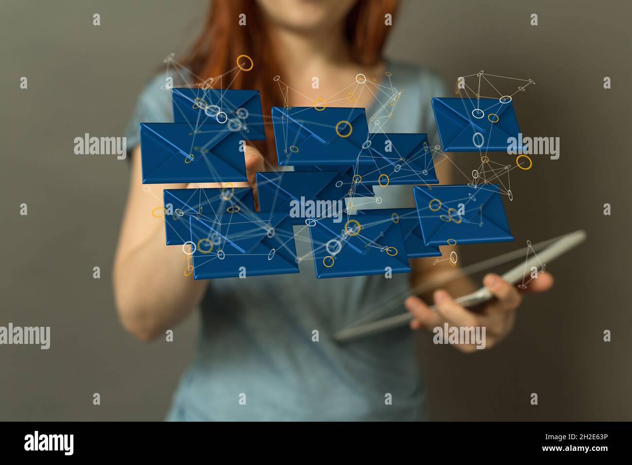 3D rendering of beige email icons concept in hand with tablet ...