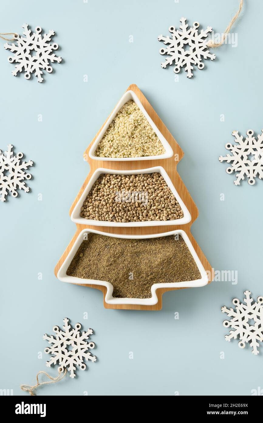 Alternative Christmas tree of hemp seeds, flour, kernels in on blue ...