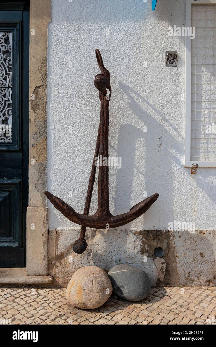 A rusty anchor hanging on a white wall Stock Photo - Alamy