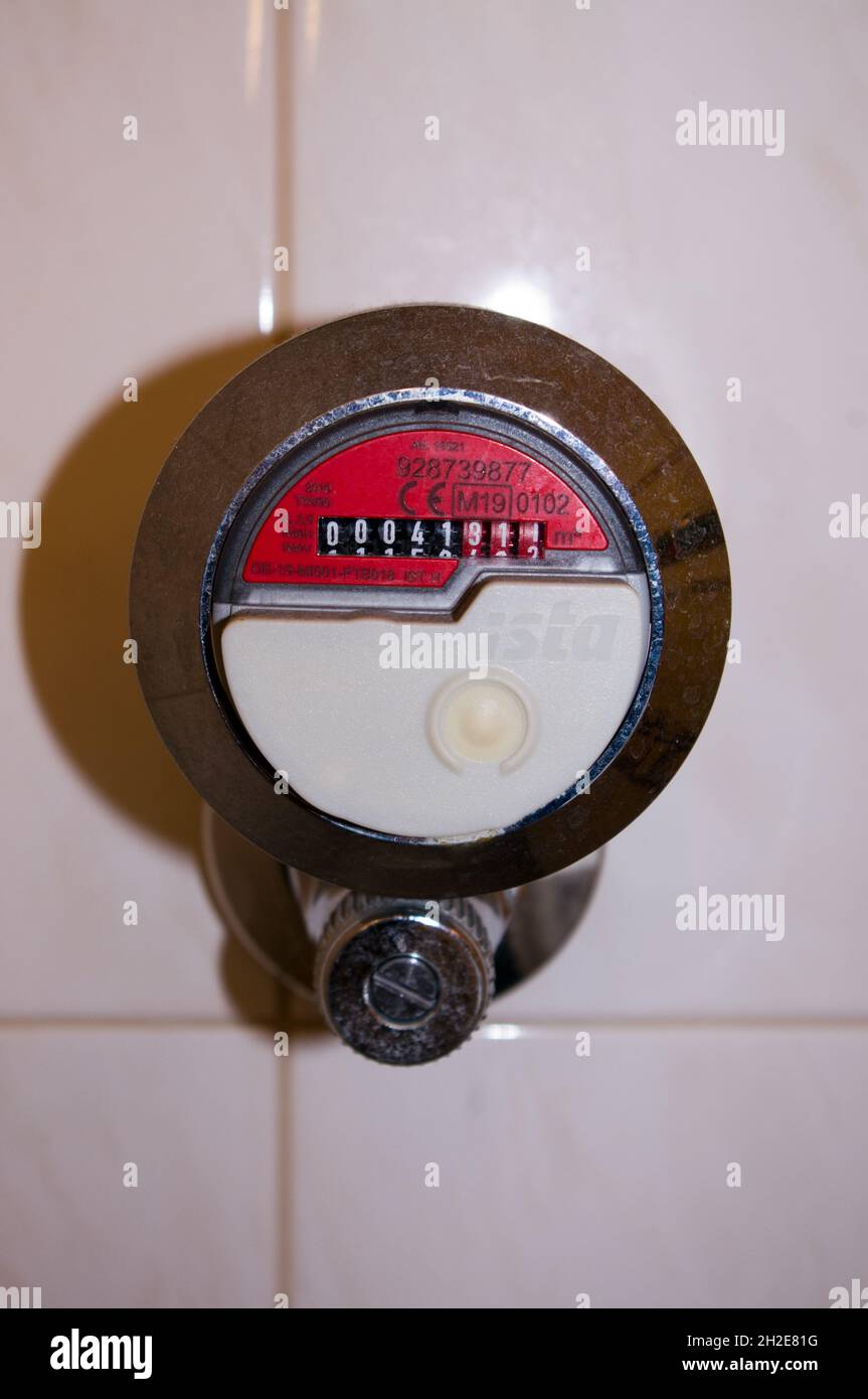 Hot water meter, isolated in front of wall tiles Stock Photo - Alamy