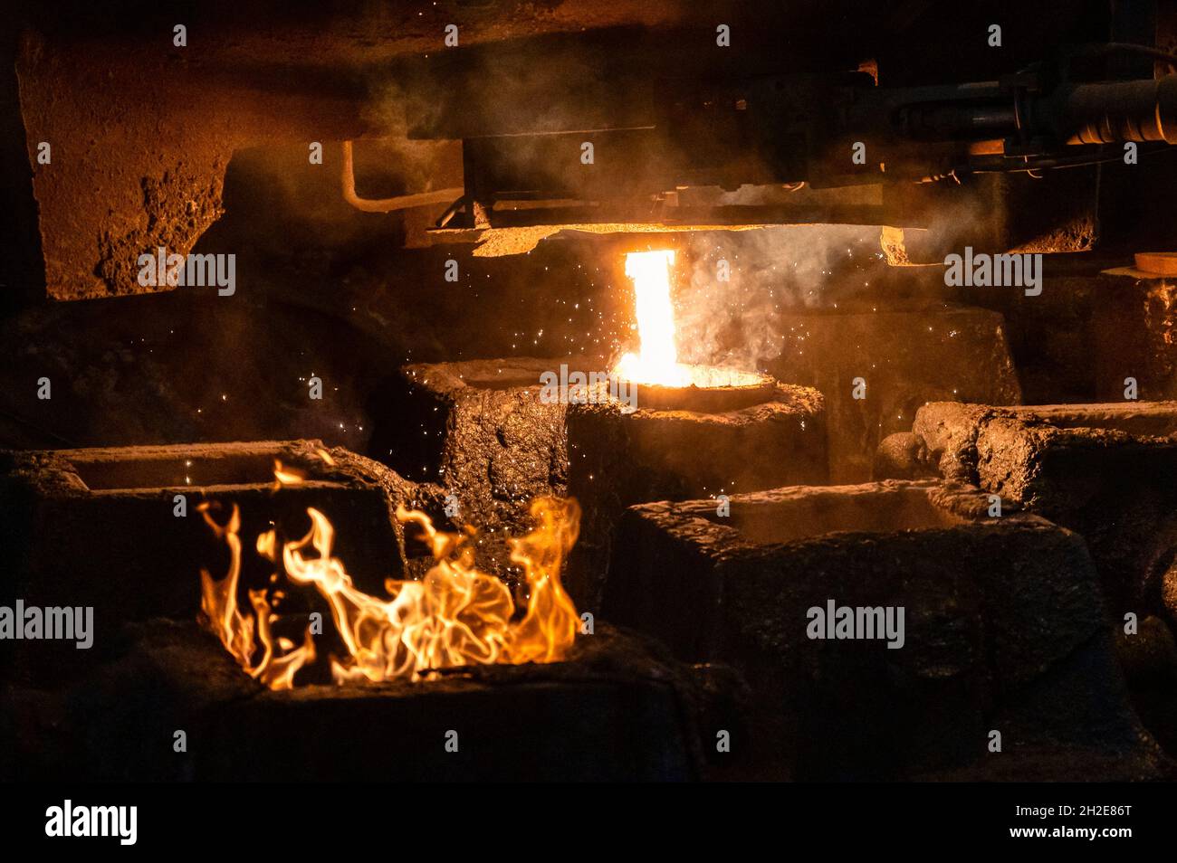 Liquid metal is poured into steel molds from metallurgical ladle Stock ...