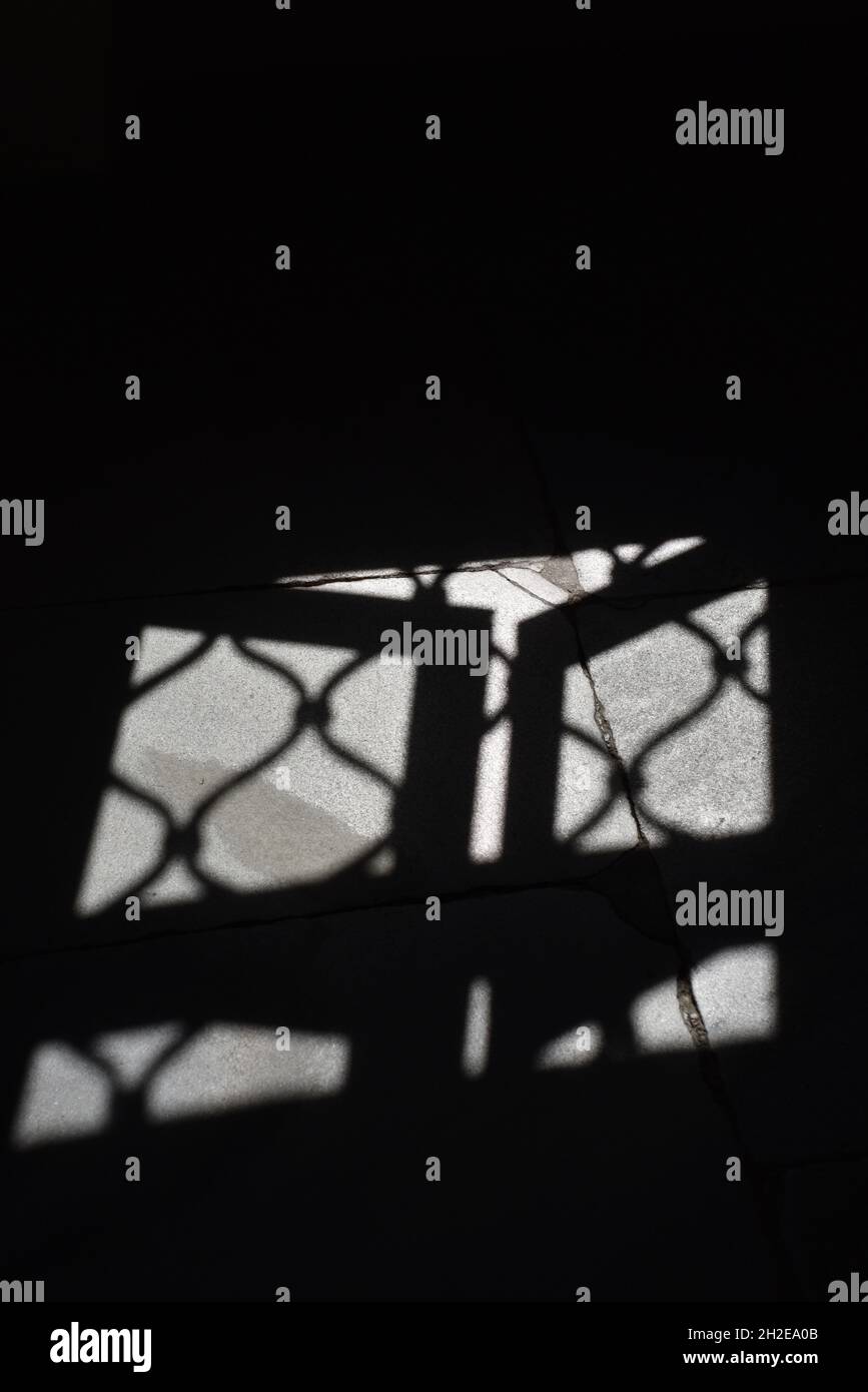 Shadow of the window with a wire fence in a dark room Stock Photo - Alamy