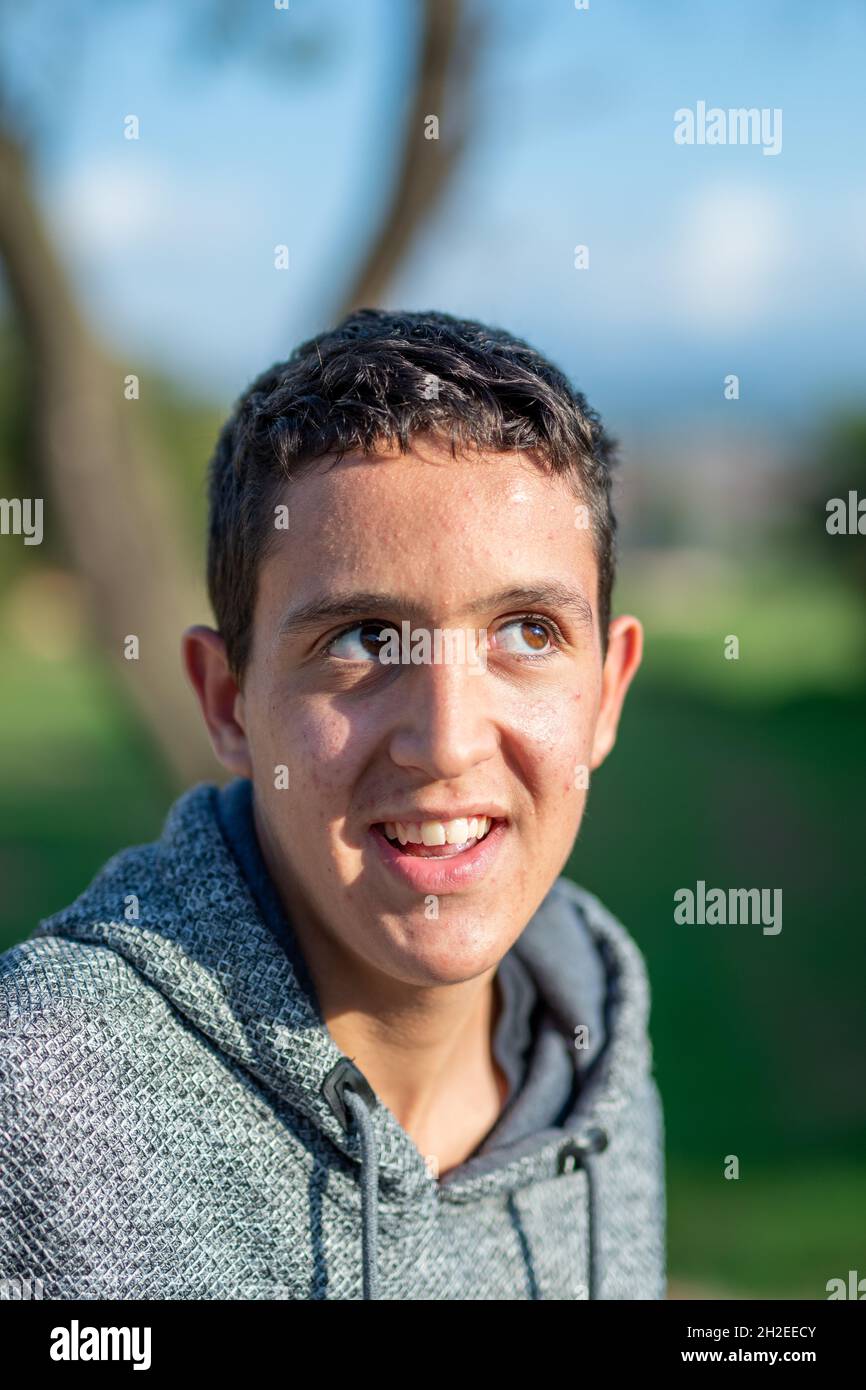 Half body shot of latin teenage boy with black hair wearing grey ...