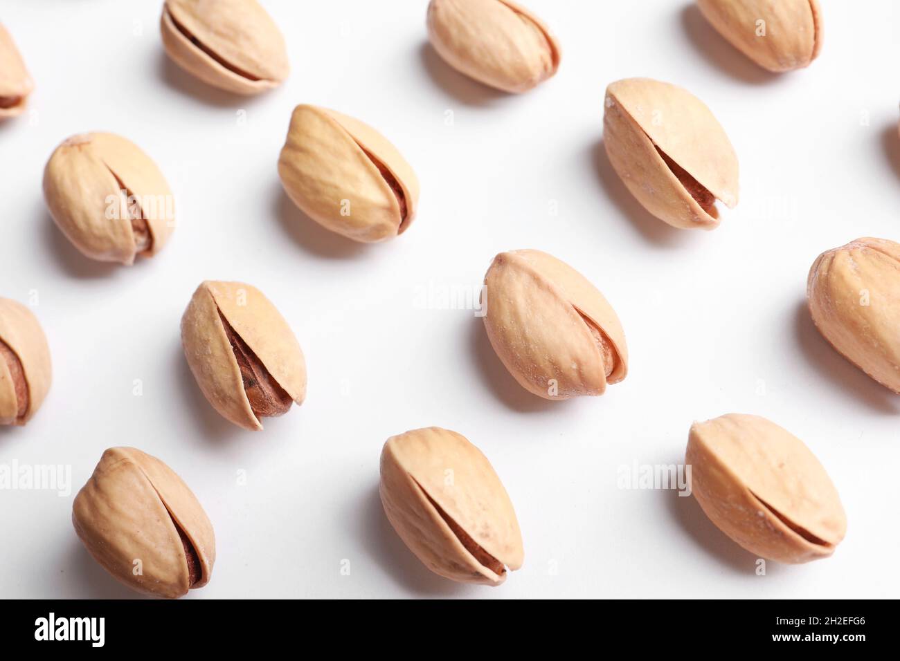 Organic pistachio nuts in shell on white background Stock Photo - Alamy