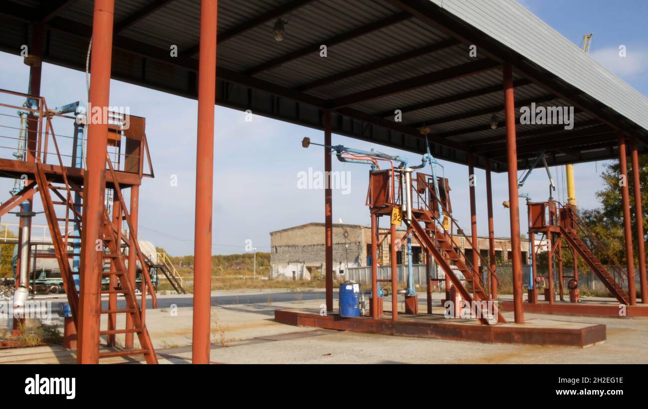 Oil pumps at the oil depot. Stock. Old tank farm on a Sunny day. Fuel ...
