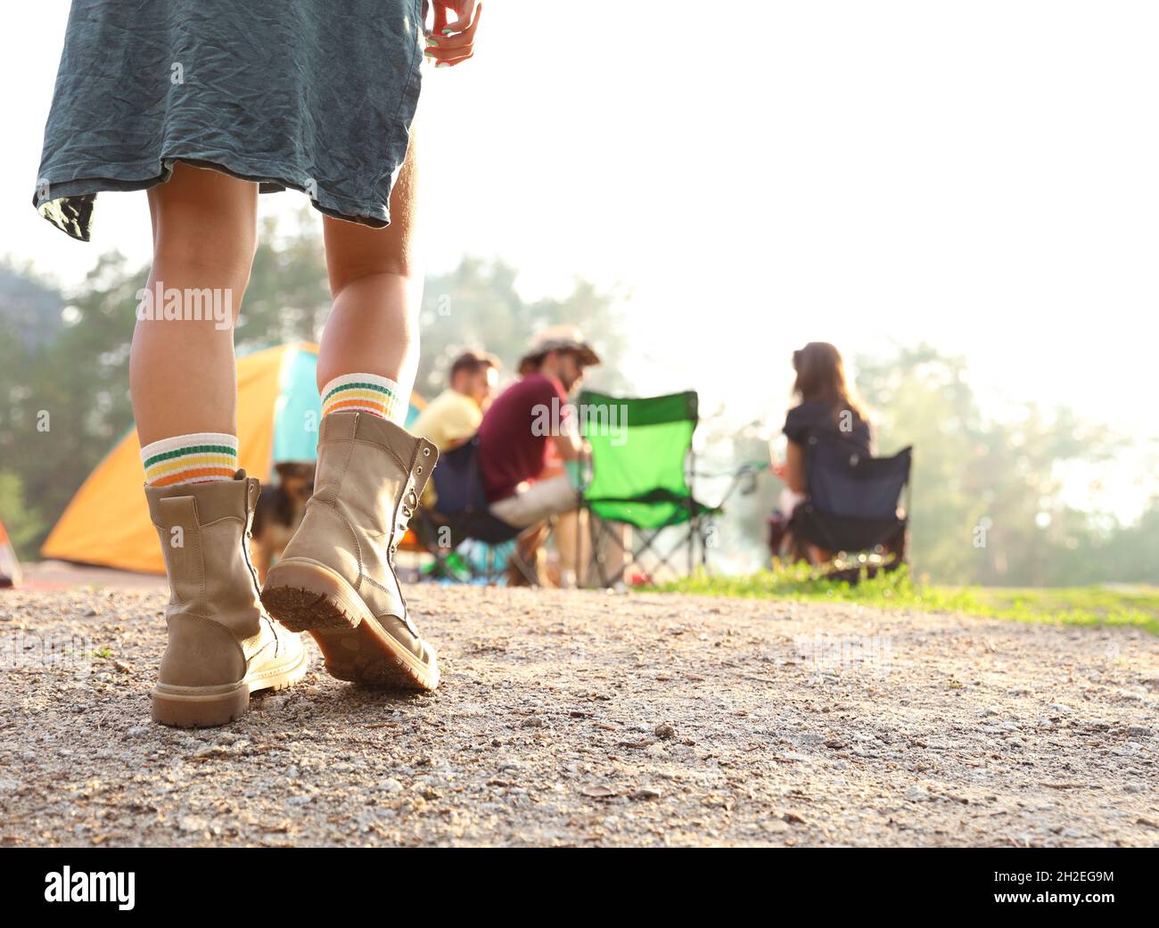 Young woman near camping tent in wilderness, focus on legs Stock Photo ...
