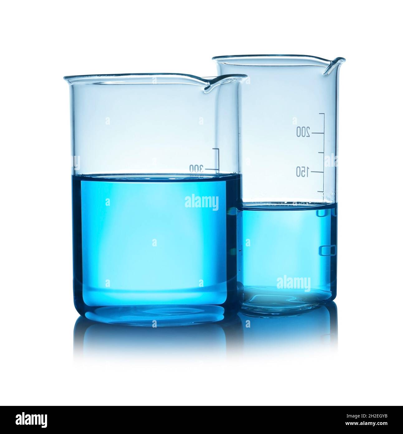 Beakers with liquid on table against color background. Laboratory ...