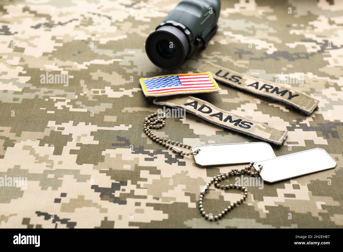 Military ID tags, patches and monocular on camouflage background Stock ...