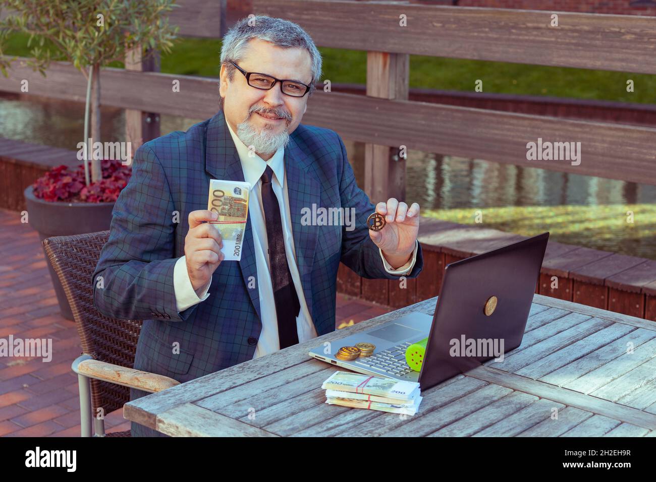 Man financier holds money in his hands and bitcoins. He made money with ...