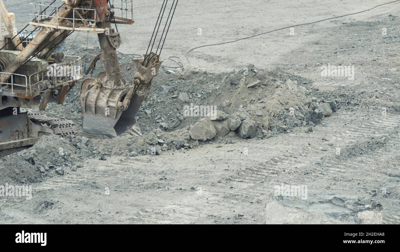 Close-up of mining excavator scooped up the ore with a bucket. Quarry ...