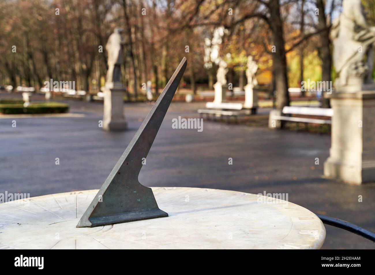 Old solar clock in Warsaw park at autumn Stock Photo - Alamy
