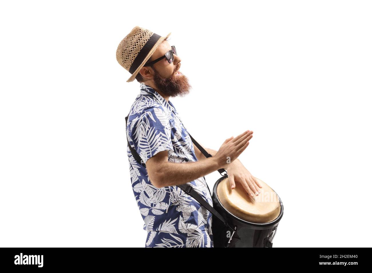 Profile shot of a bearded man playing conga drums and singing isolated ...