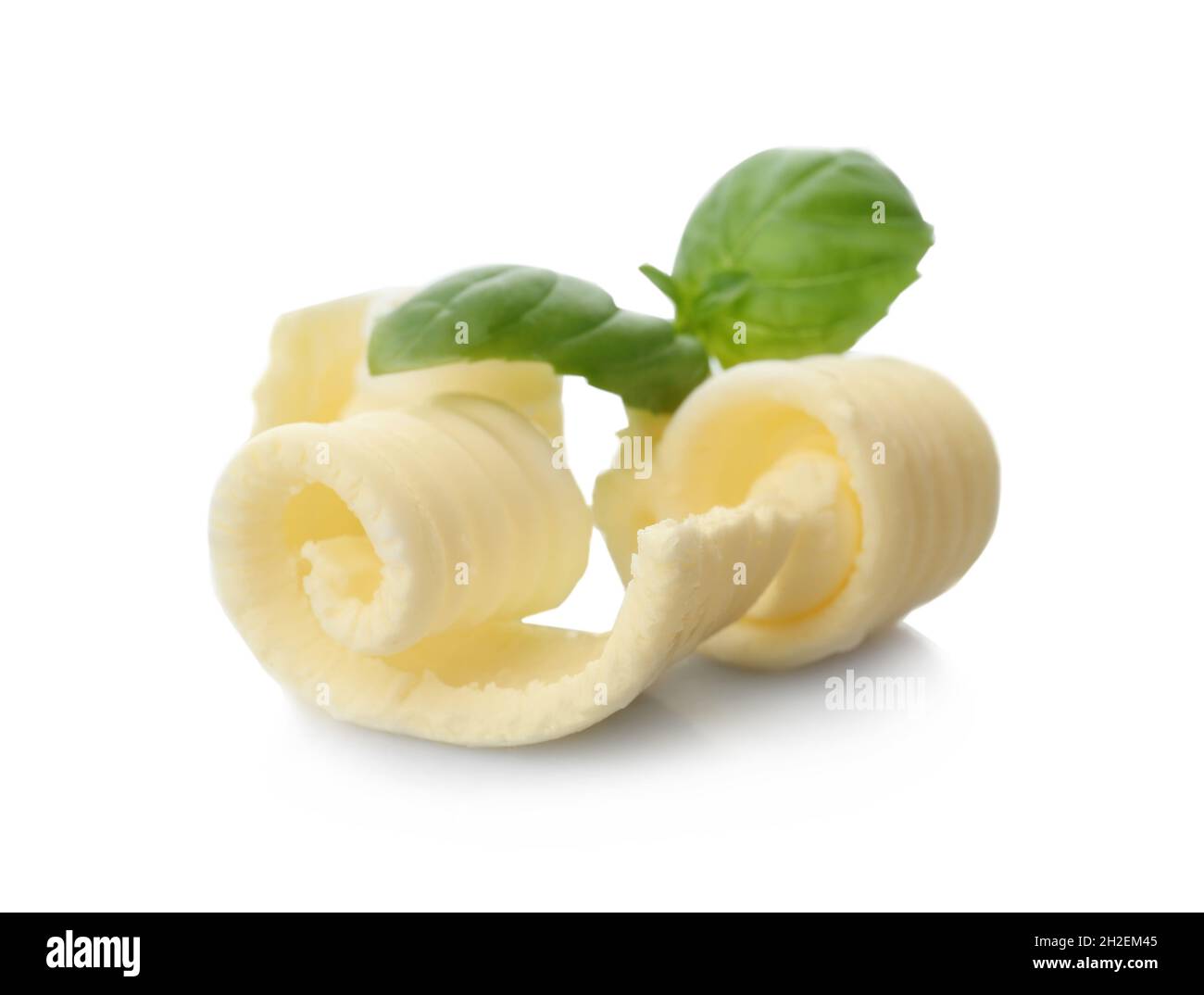 Tasty butter curls on white background Stock Photo - Alamy