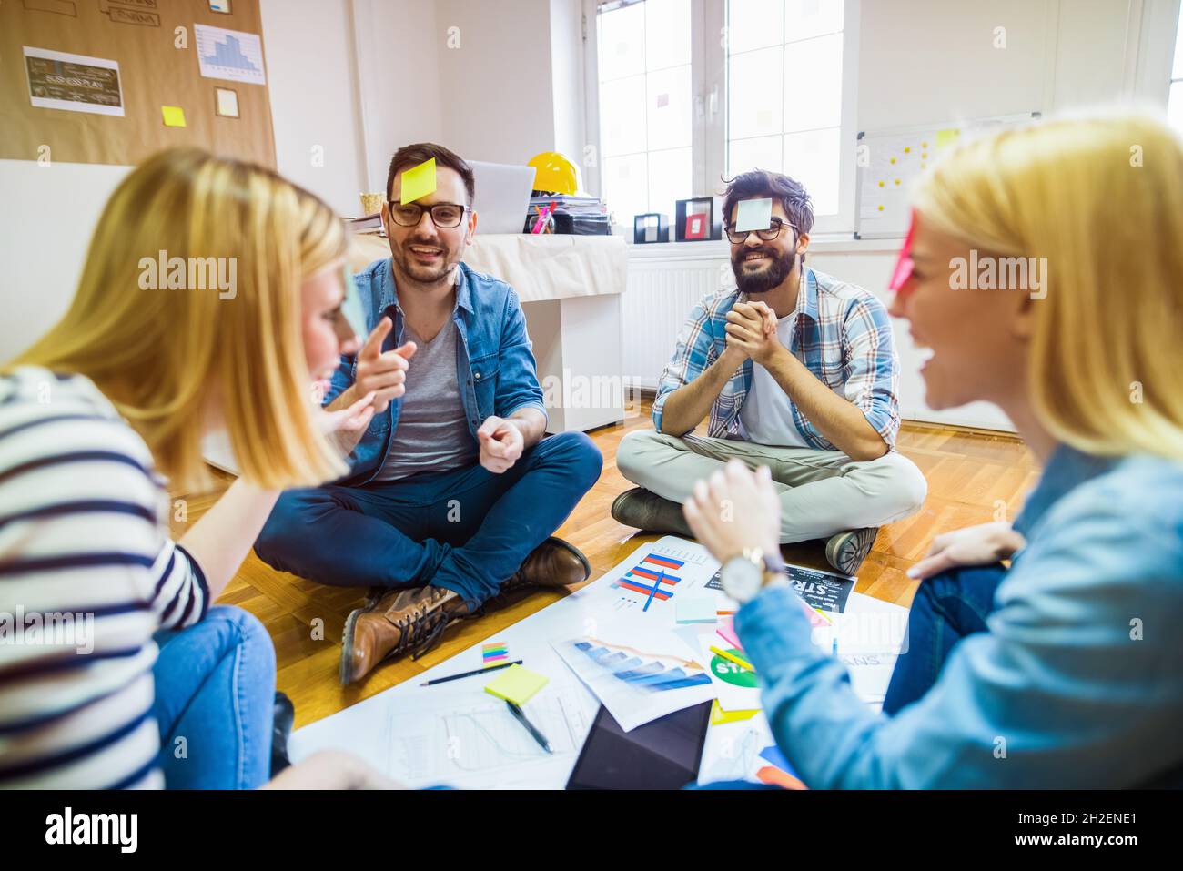 Team building. Group pf colleagues sitting in a circle and playing ...