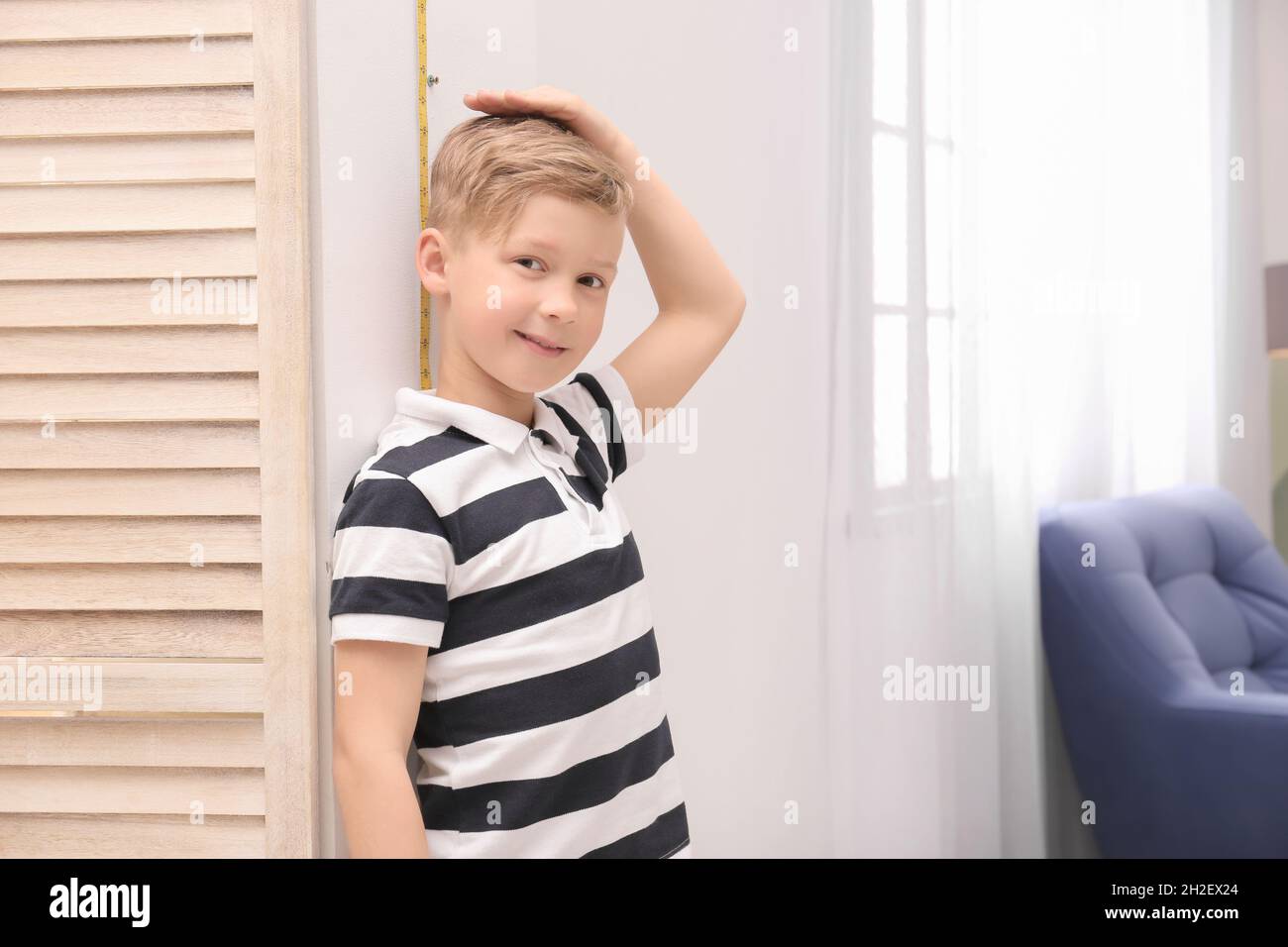 Little boy measuring his height at home Stock Photo - Alamy