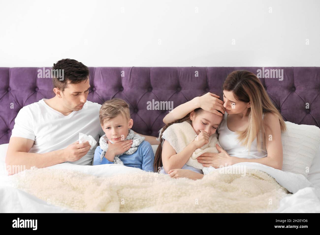 Family suffering from cold in bed at home Stock Photo - Alamy