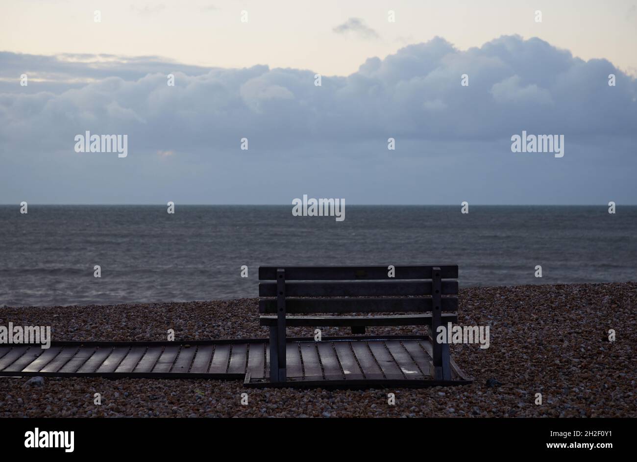 Large bench on the seafront of Aldwick beach seen in early morning ...