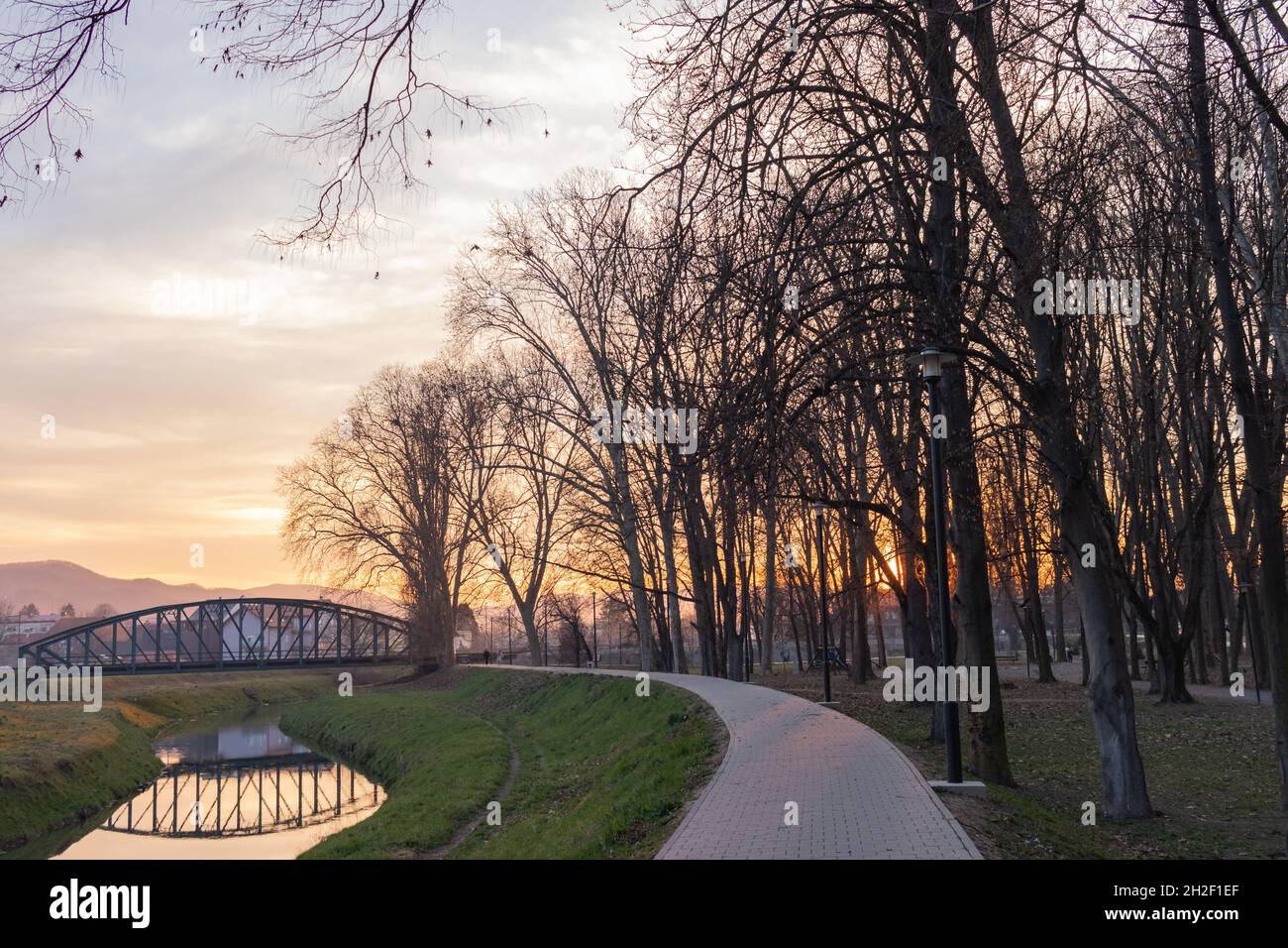 Old rusty truss bridge over the Orljava river. Promenade Stock Photo ...