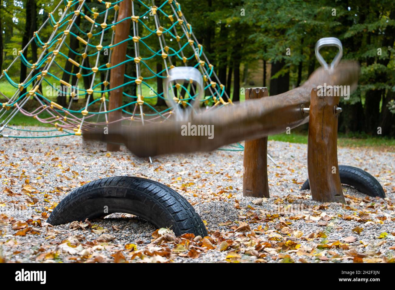 Wooden swing made of logs on the playground Stock Photo - Alamy