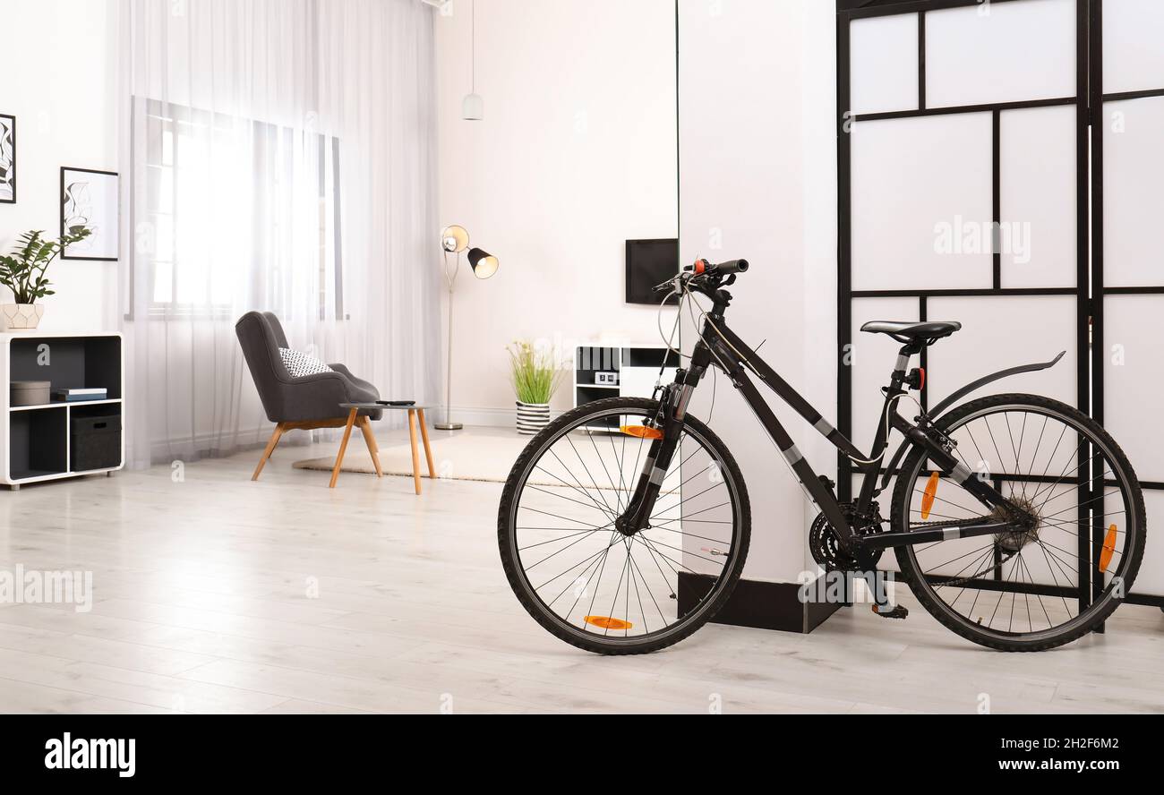 Light living room interior with modern bicycle Stock Photo - Alamy