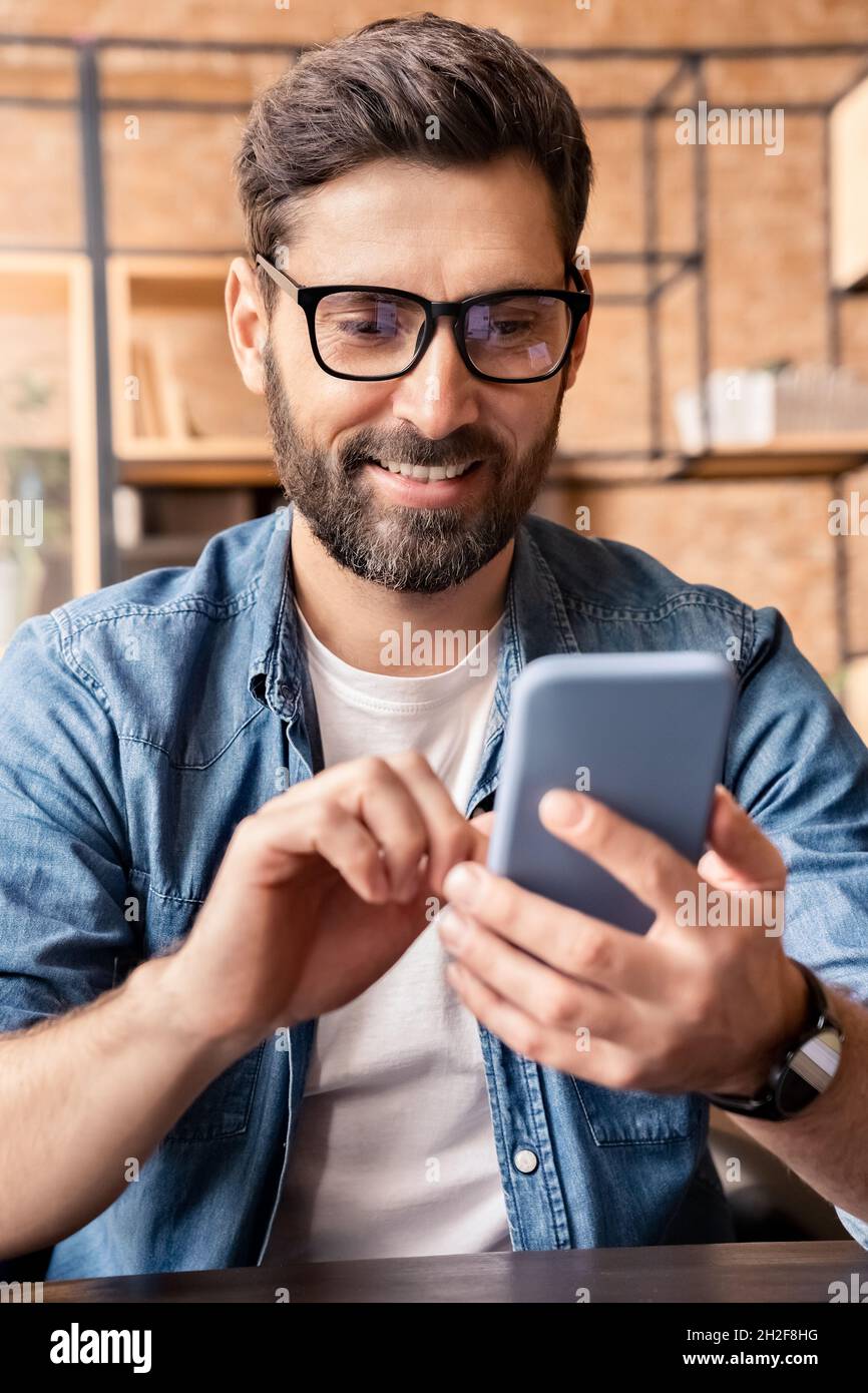 Happy smiling business man using mobile phone for online conversation ...