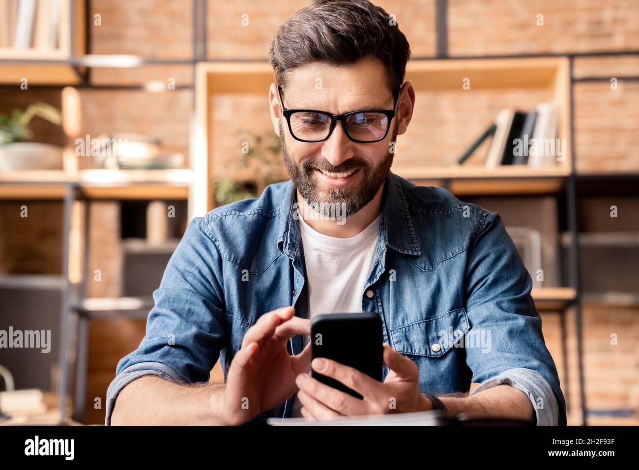 Happy smiling business man using smartphone device headshot portrait ...