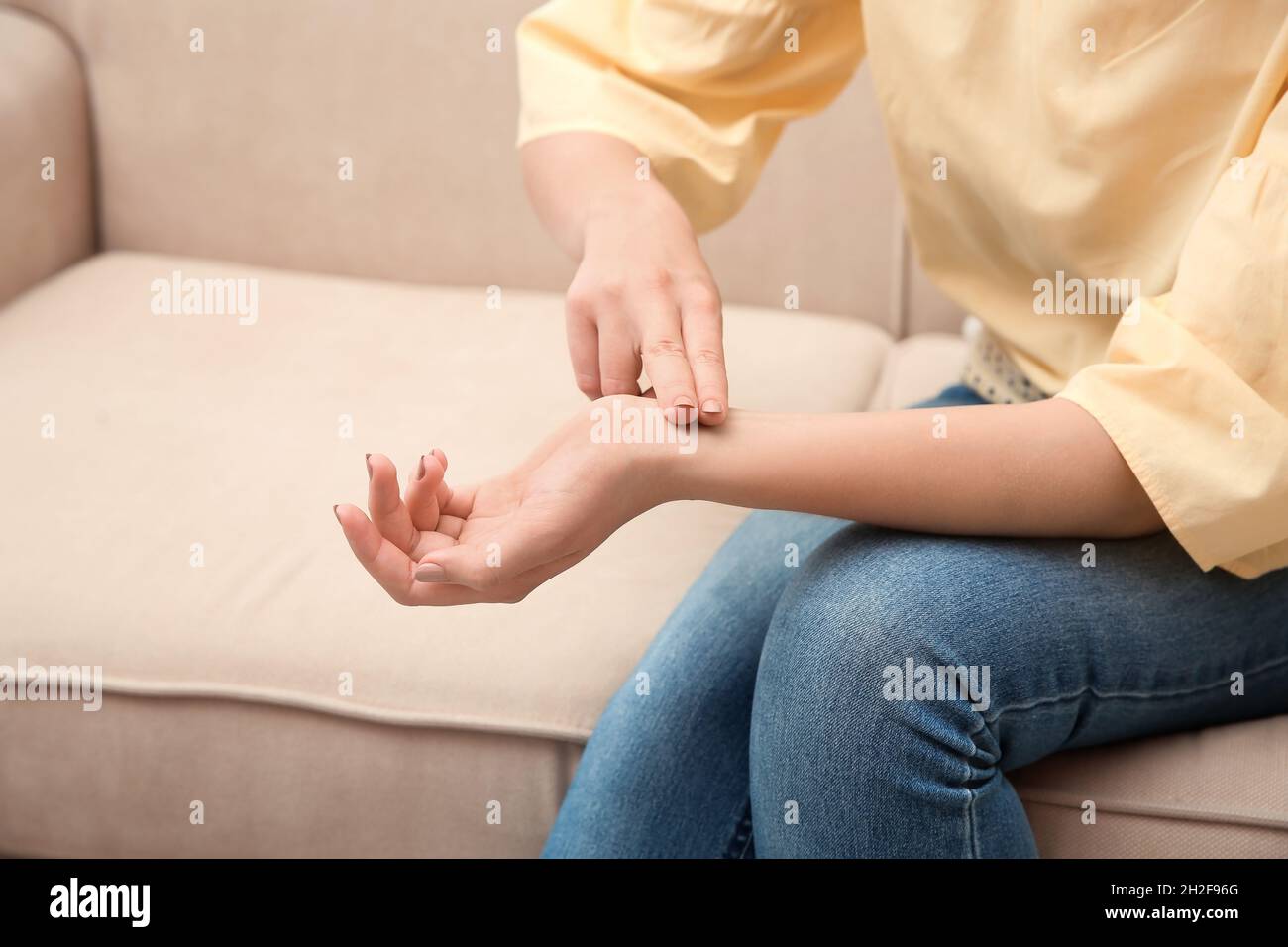 Young woman checking pulse at home, closeup Stock Photo - Alamy