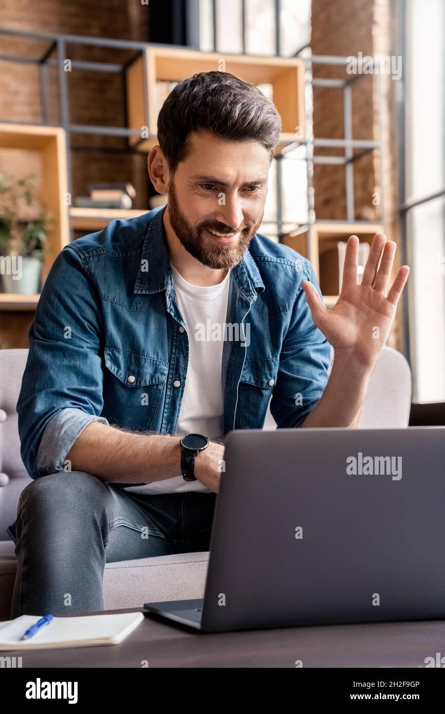 Man waving hand holding business video conference greeting interlocutor ...