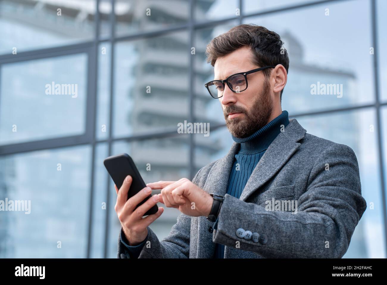 Person with mobile outside office hi-res stock photography and images ...