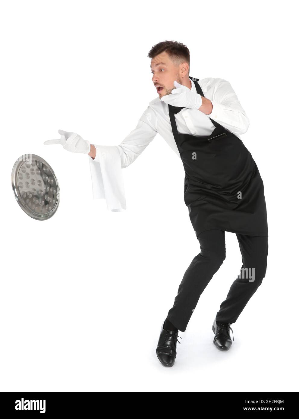 Clumsy waiter dropping empty tray on white background Stock Photo - Alamy