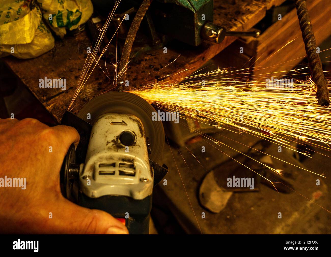 incandescent metal filings coming out of a killing cutting machine ...