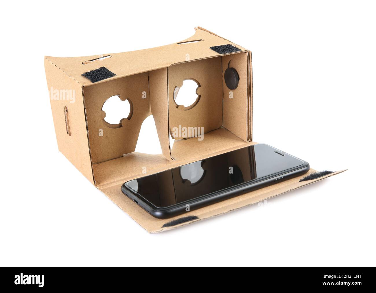 Cardboard virtual reality headset and smartphone on white background ...