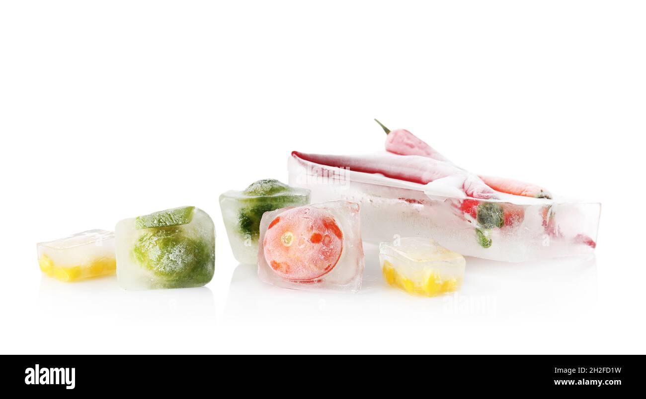 Fresh vegetables frozen in ice cubes on white background Stock Photo ...