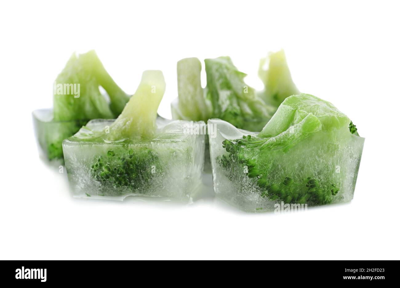 Fresh broccoli in ice cubes on white background. Frozen vegetables ...