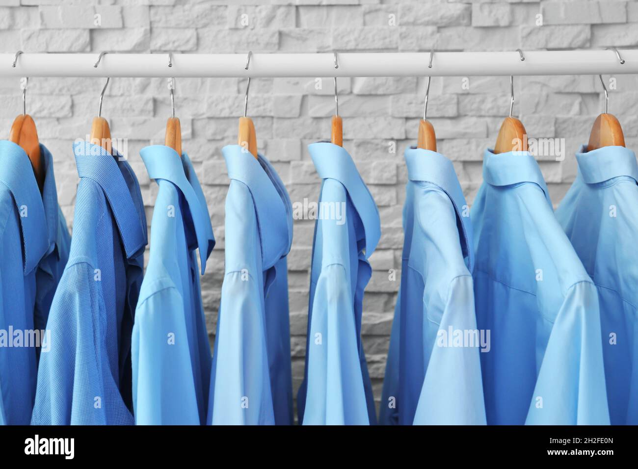 Rack with clean clothes on hangers after dry-cleaning indoors Stock ...