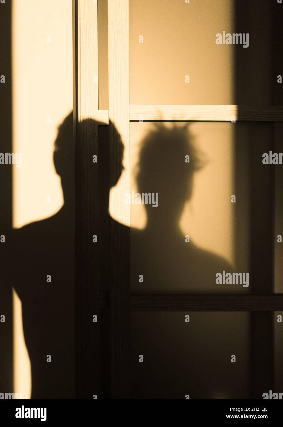 warm sunny hard shadows of couple at interior Stock Photo - Alamy