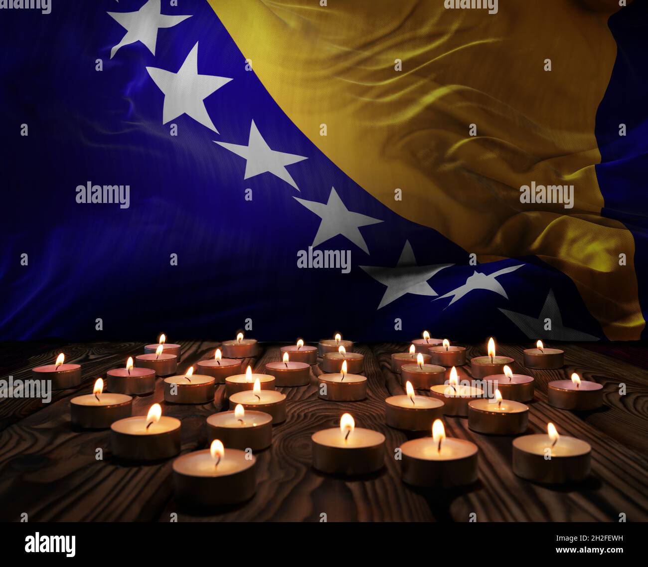 Mourning candles burning on Bosnia and Herzegovina national flag ...