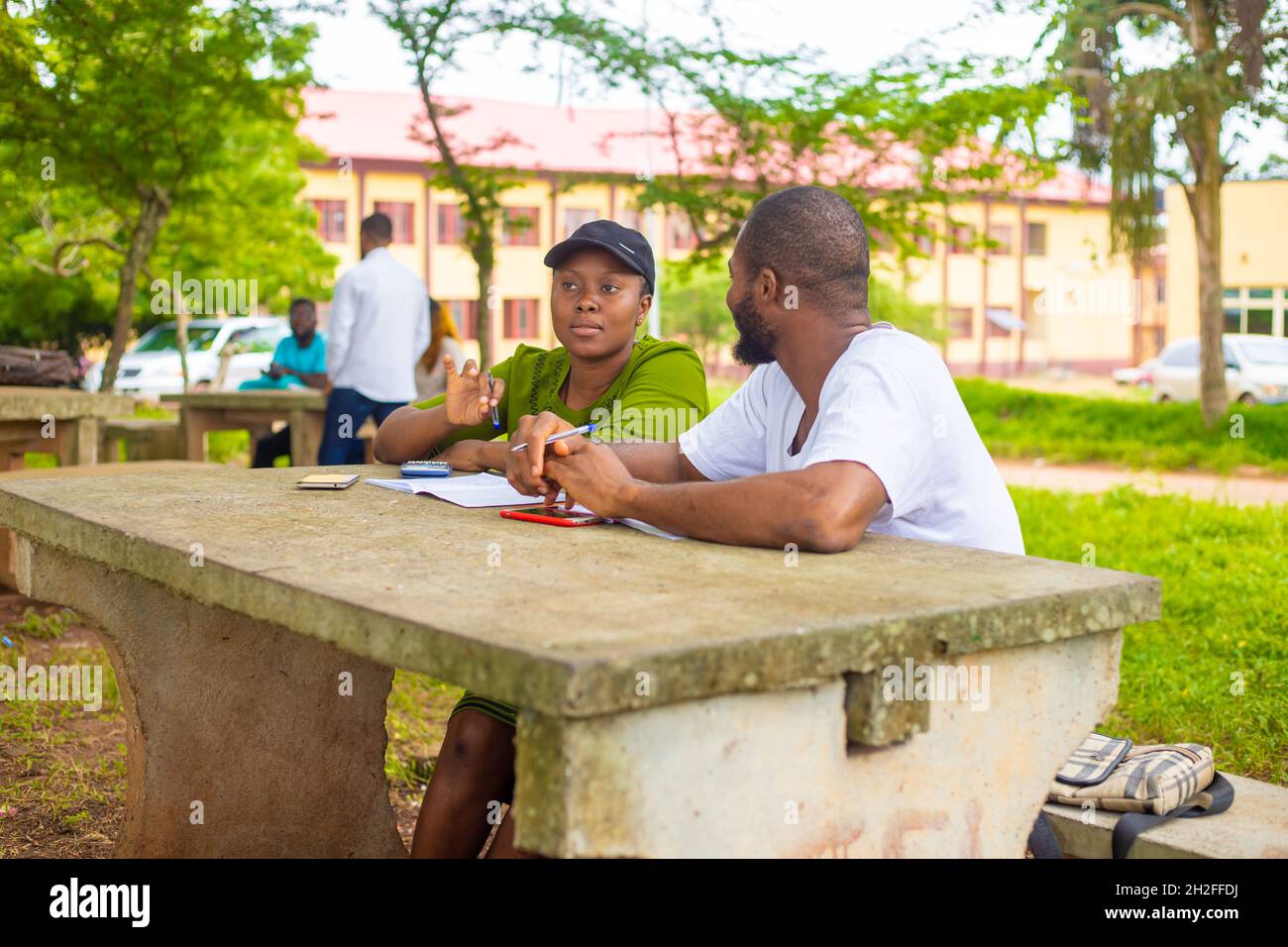interaction between two african student over their studies Stock Photo ...
