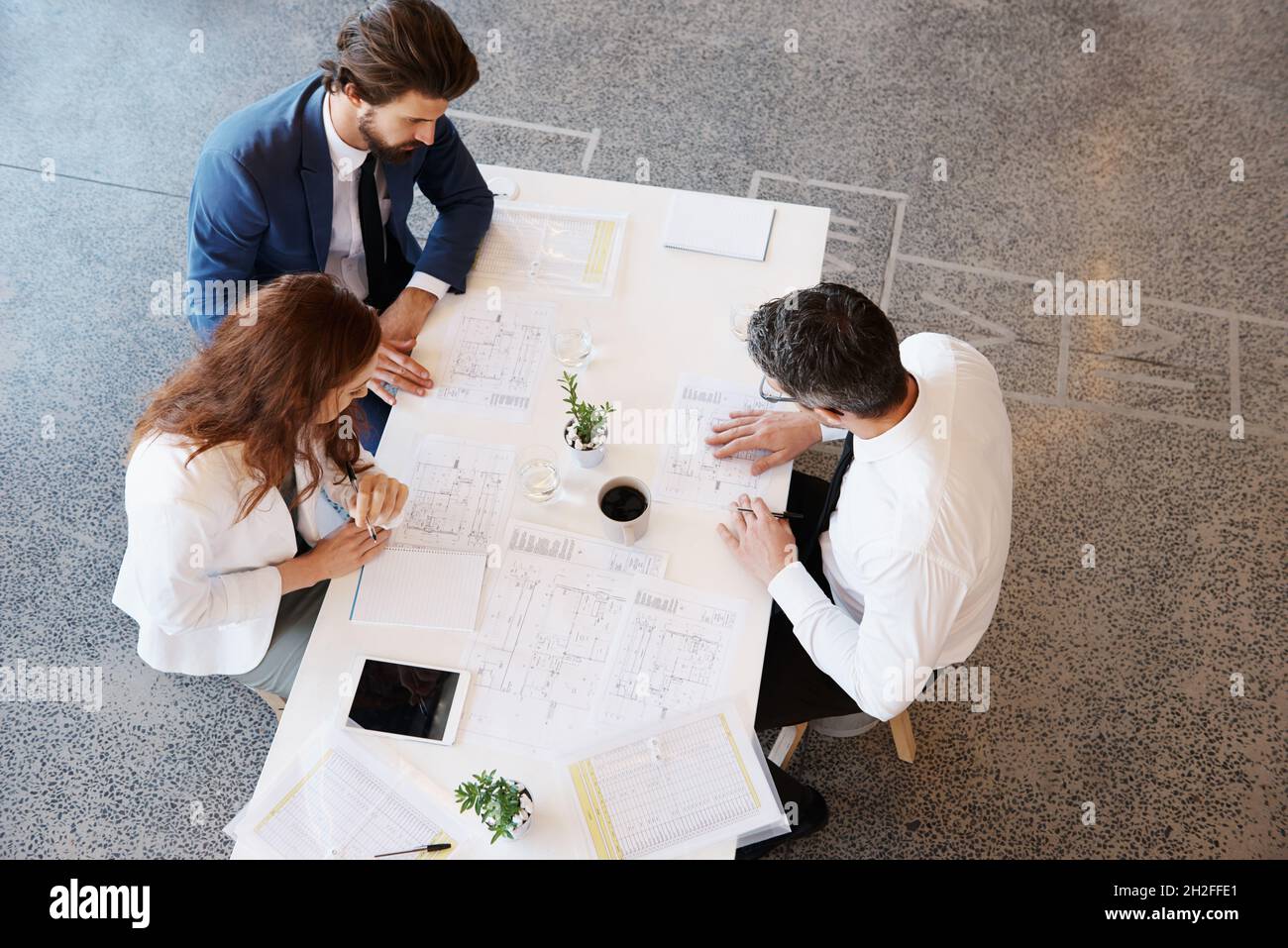 Business people working on blueprints hi-res stock photography and ...