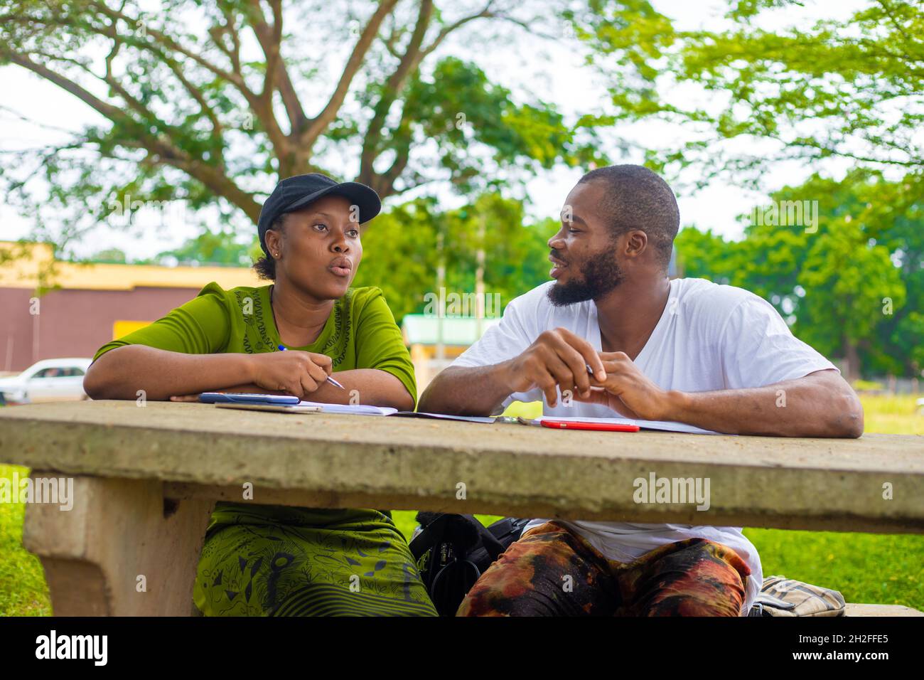 interaction between two african student over their studies Stock Photo ...
