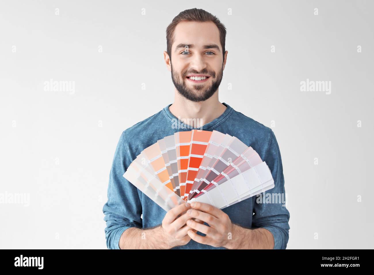 Young man with color palette on white background Stock Photo - Alamy