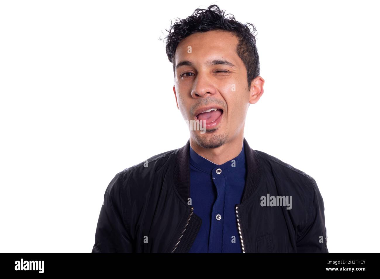 Latin man winking, isolated on white background. Man with beard winking ...