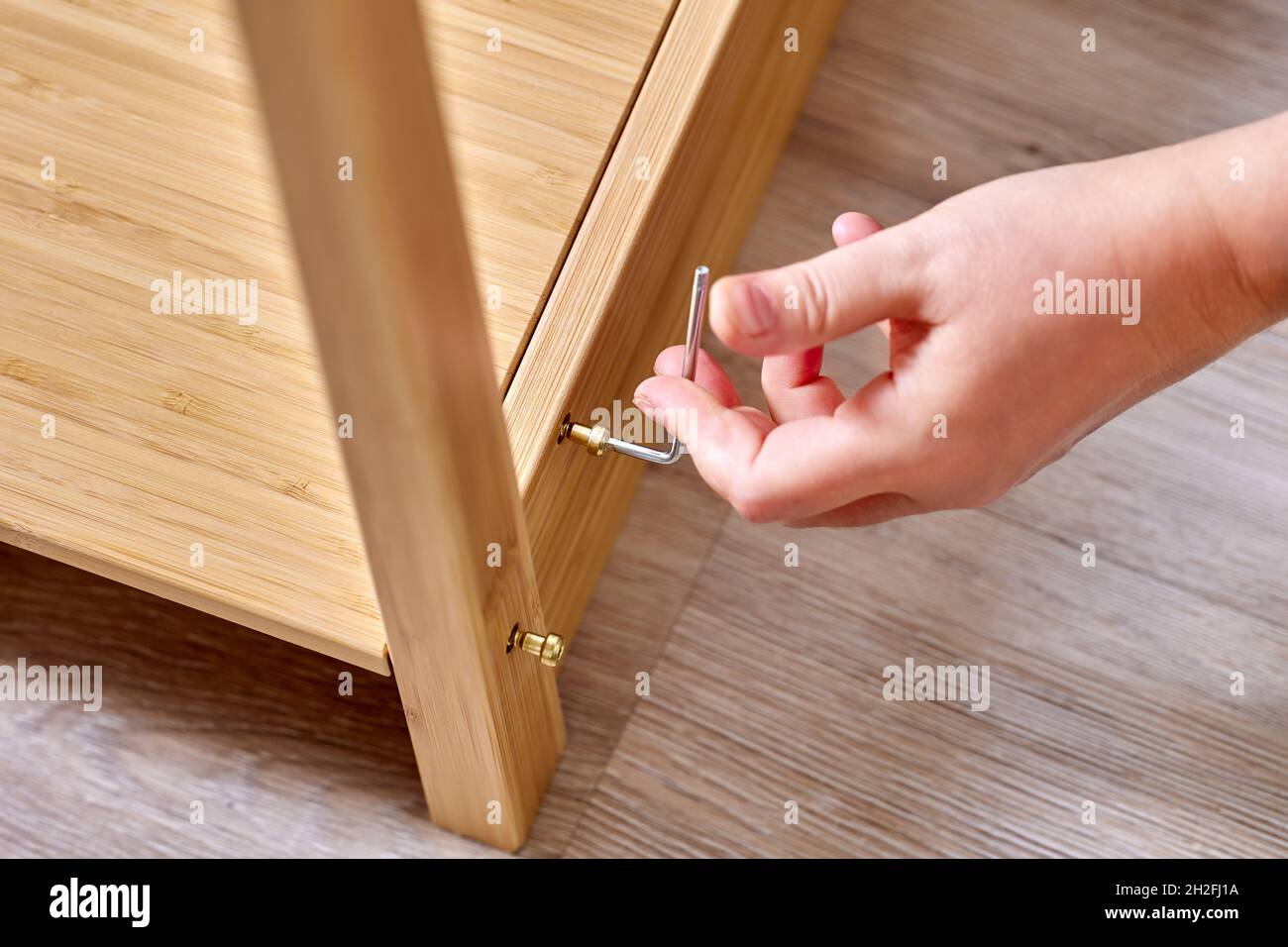 Handyman Is Assembling Flat Pack Furniture Using Screws And Tool Stock