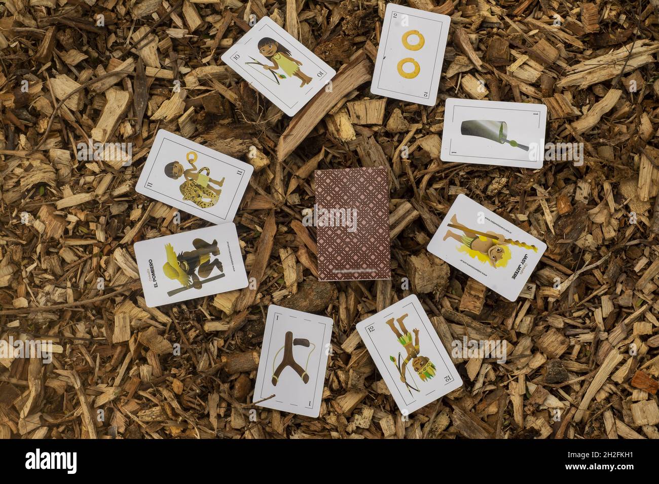 High angle closeup of game cards placed around a flipped card on the ...