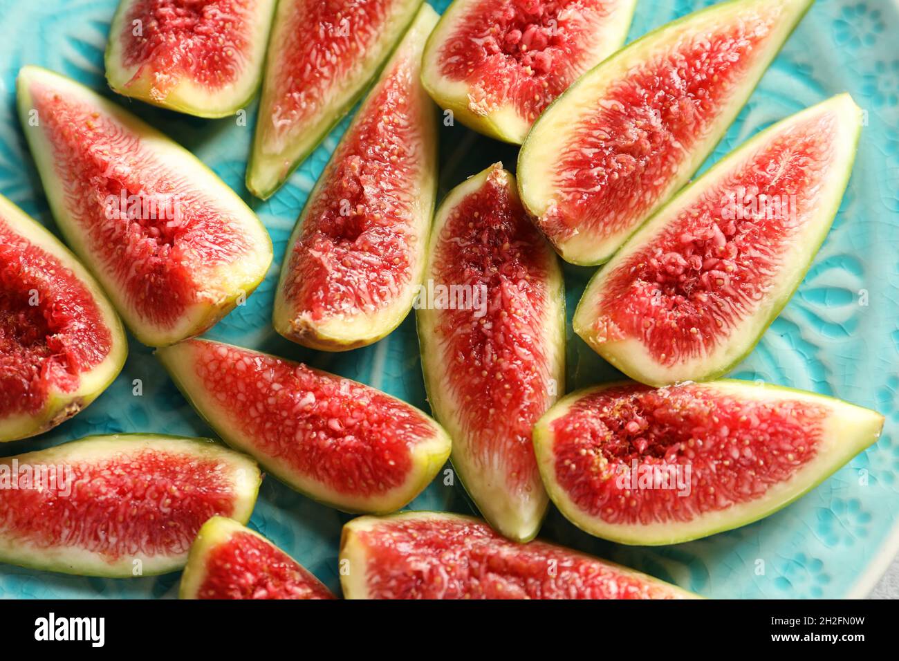 Plate with fresh ripe fig slices, top view. Tropical fruit Stock Photo ...